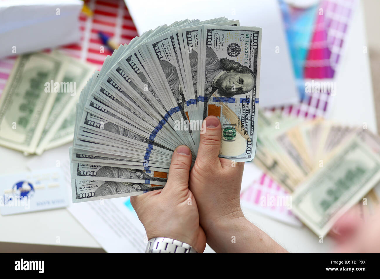 Male hands counting money from huge pack Stock Photo - Alamy