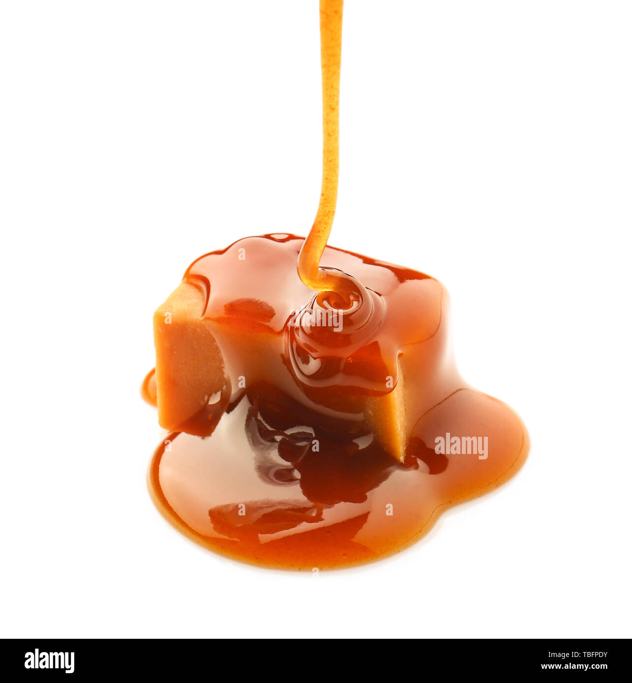 Liquid caramel pouring on candy against white background Stock Photo ...