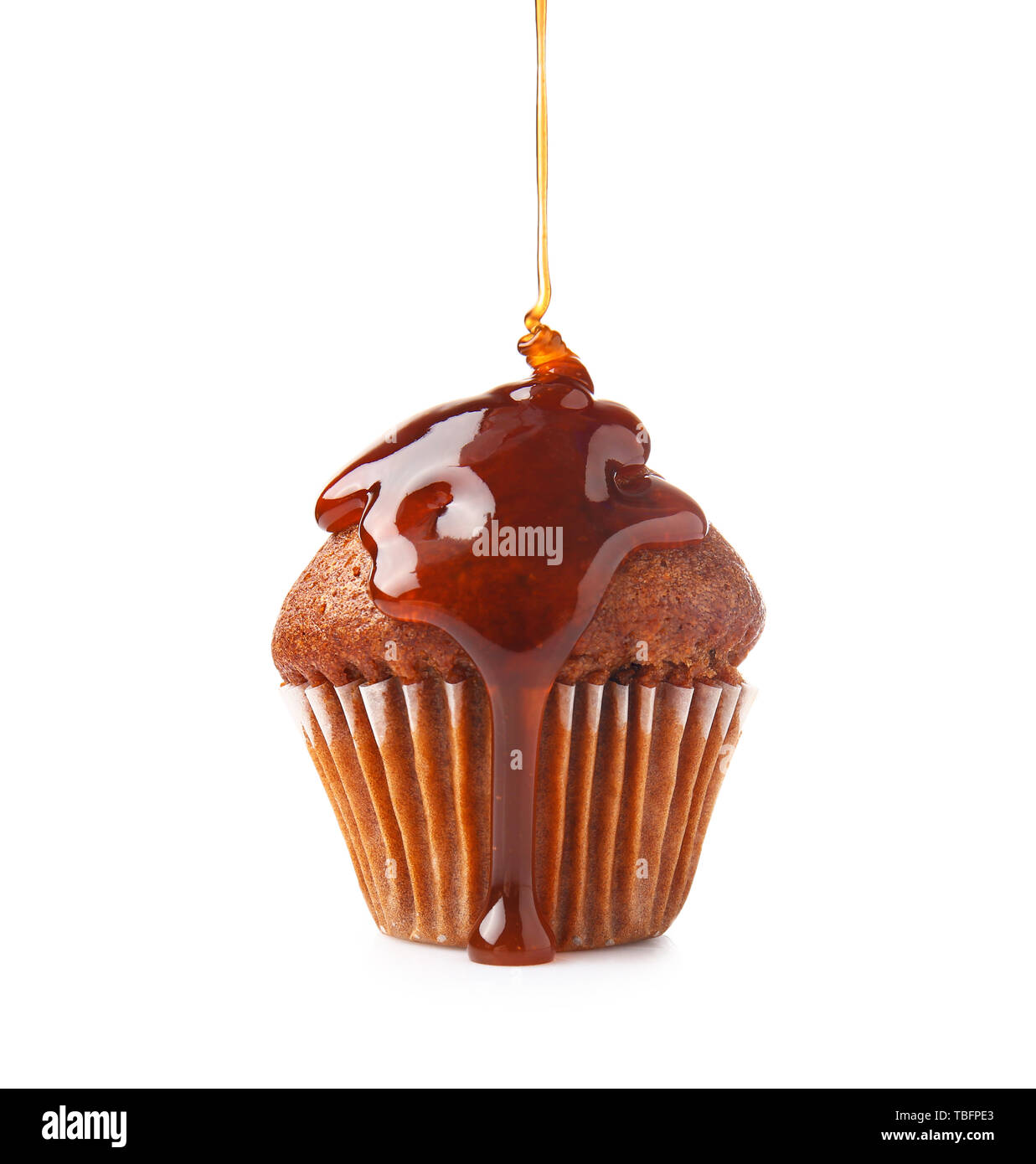 Liquid caramel pouring on muffin against white background Stock Photo ...