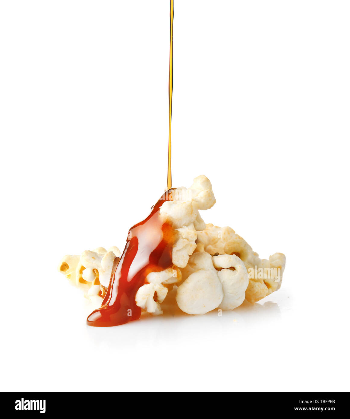 Liquid caramel pouring on popcorn against white background Stock Photo ...