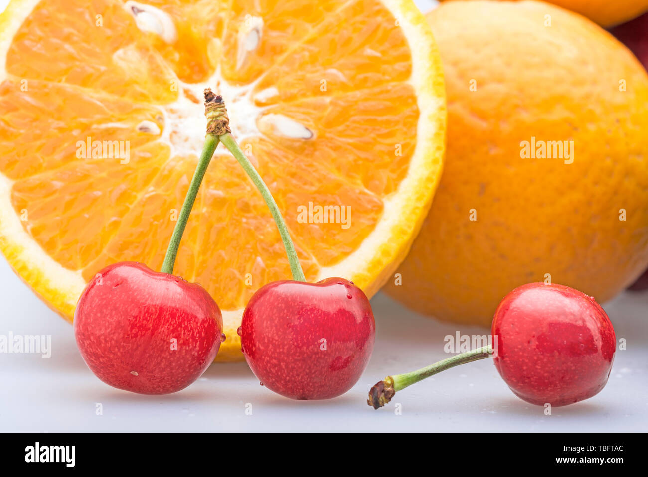 Cherries and oranges Stock Photo - Alamy