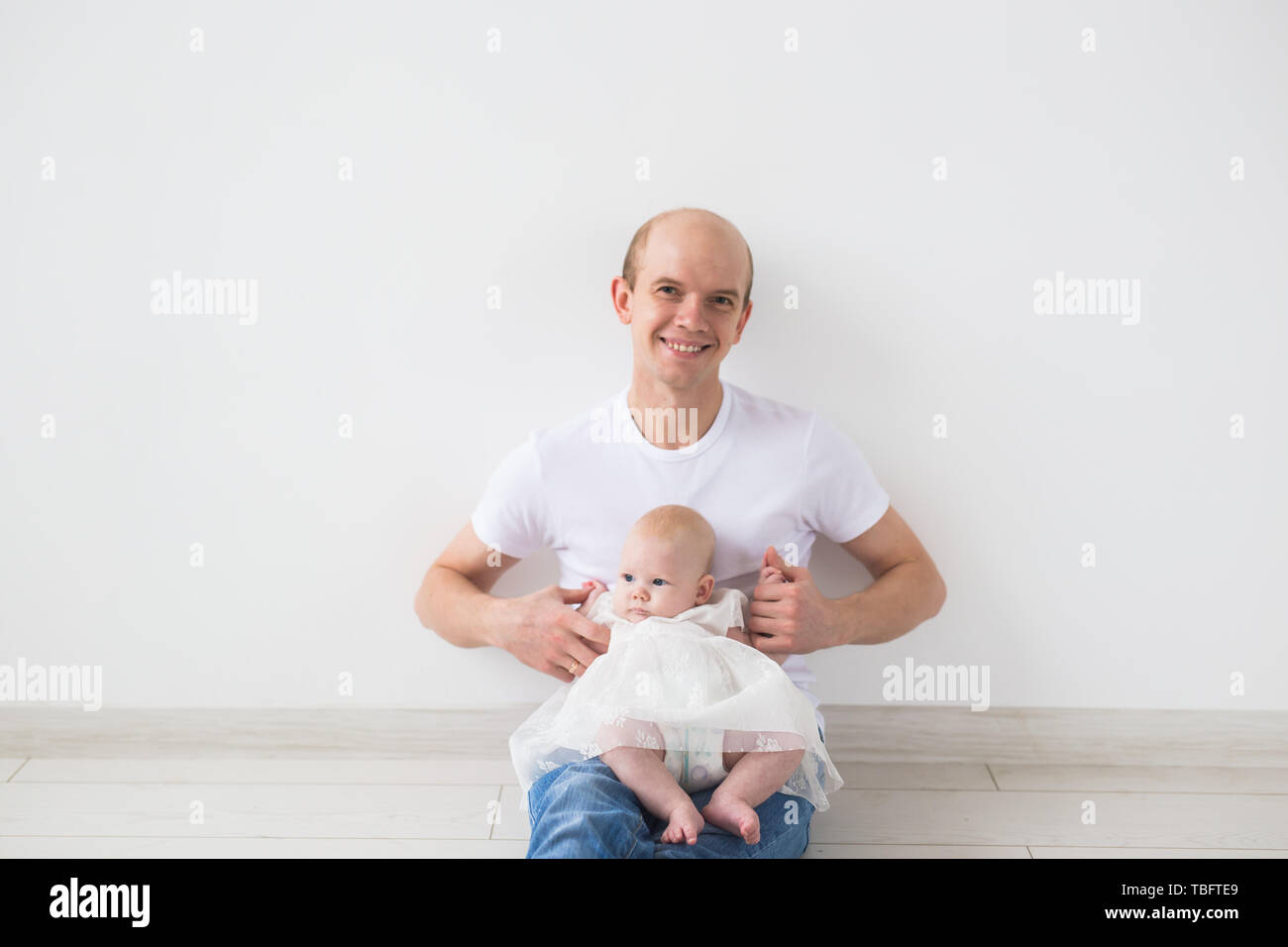 family, fatherhood and children concept - bald father holding cute ...
