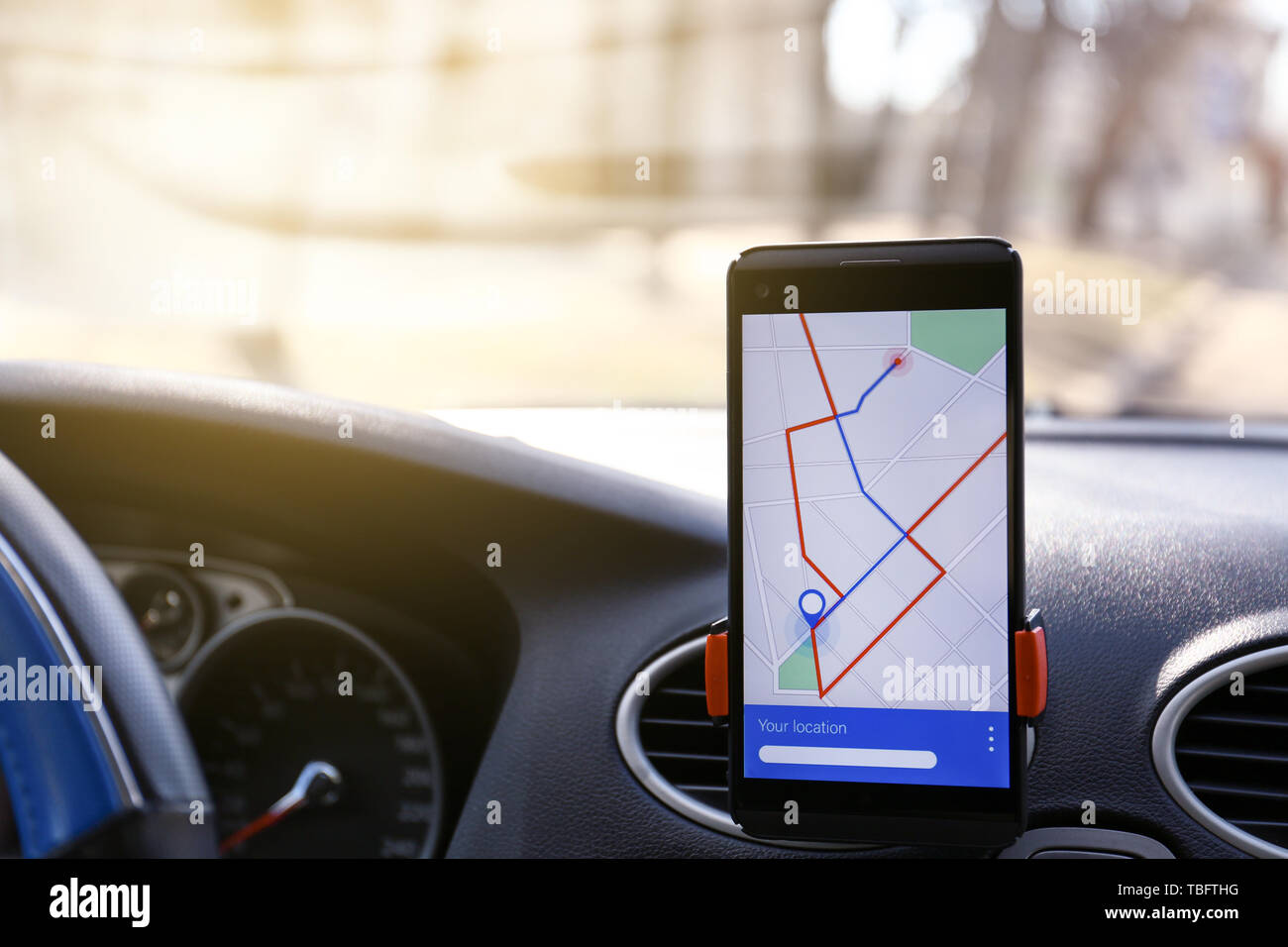 Mobile phone displaying map with route on screen for car driver Stock ...