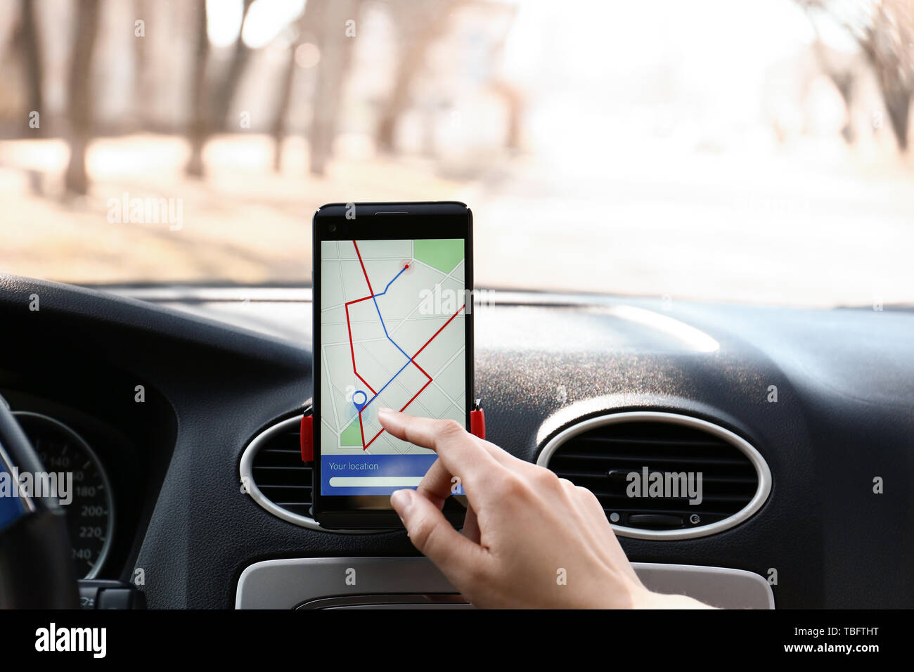 Car driver using mobile phone for navigation Stock Photo - Alamy