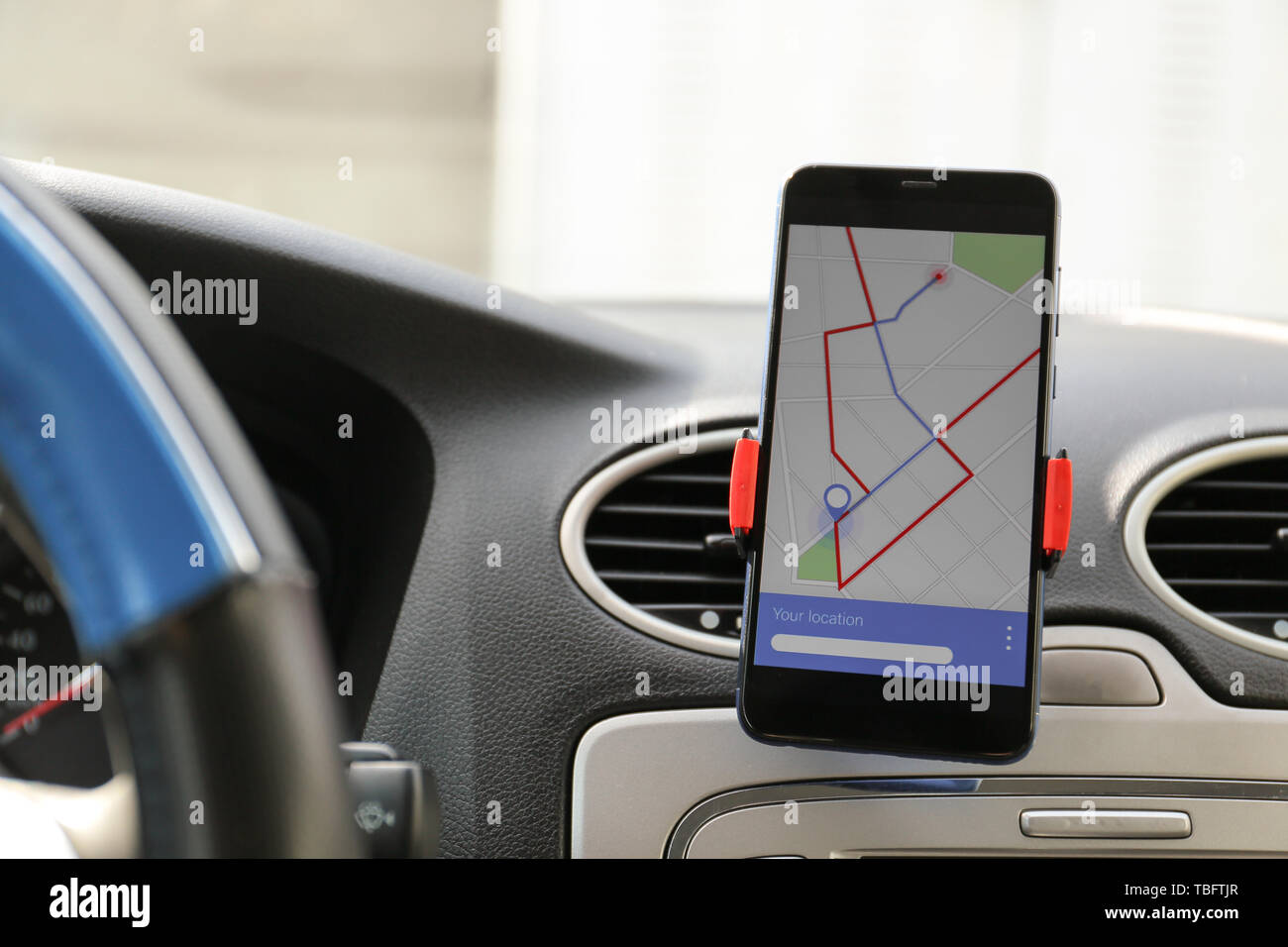 Mobile phone displaying map with route on screen for car driver Stock ...
