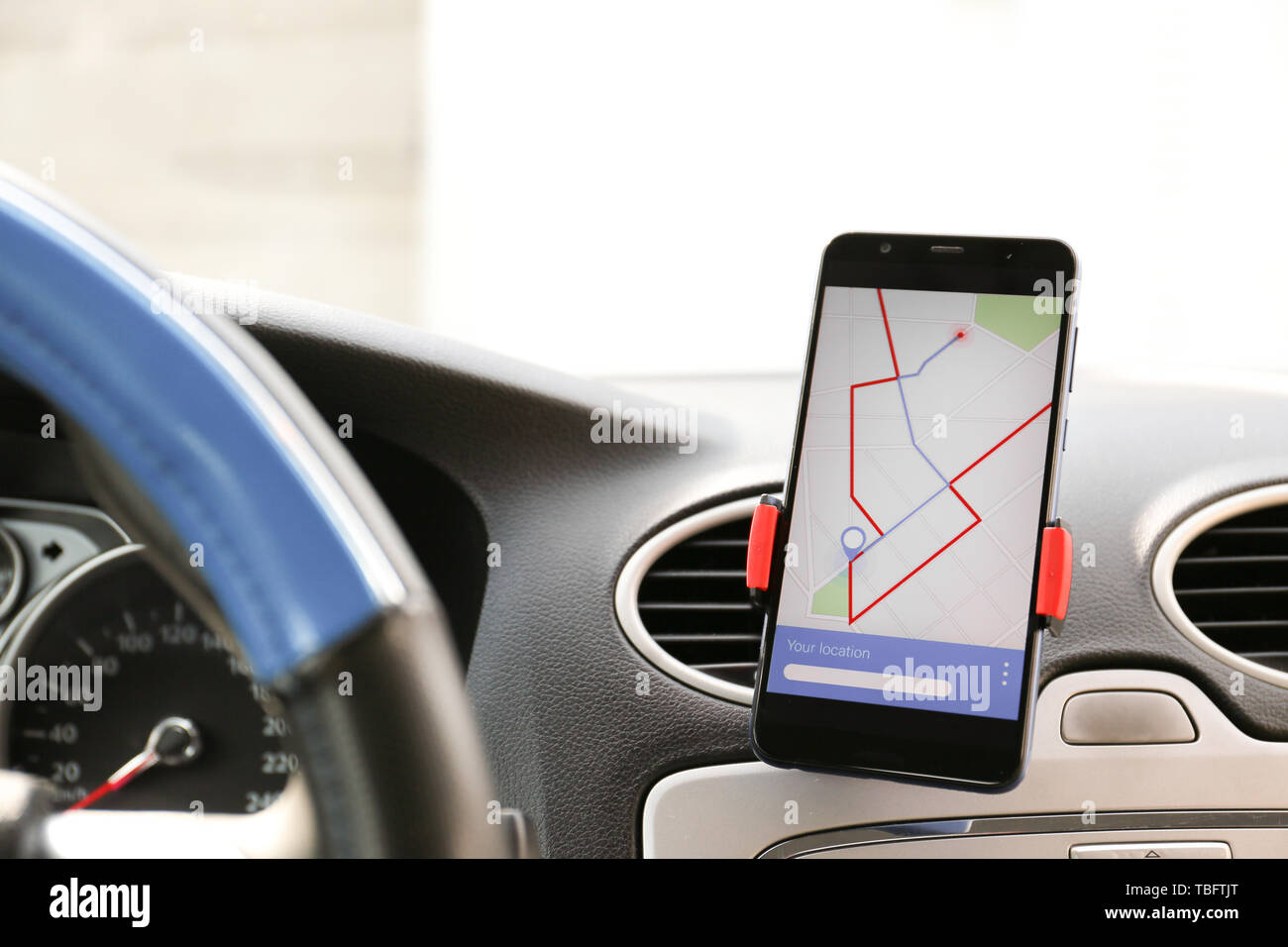 Mobile phone displaying map with route on screen for car driver Stock ...