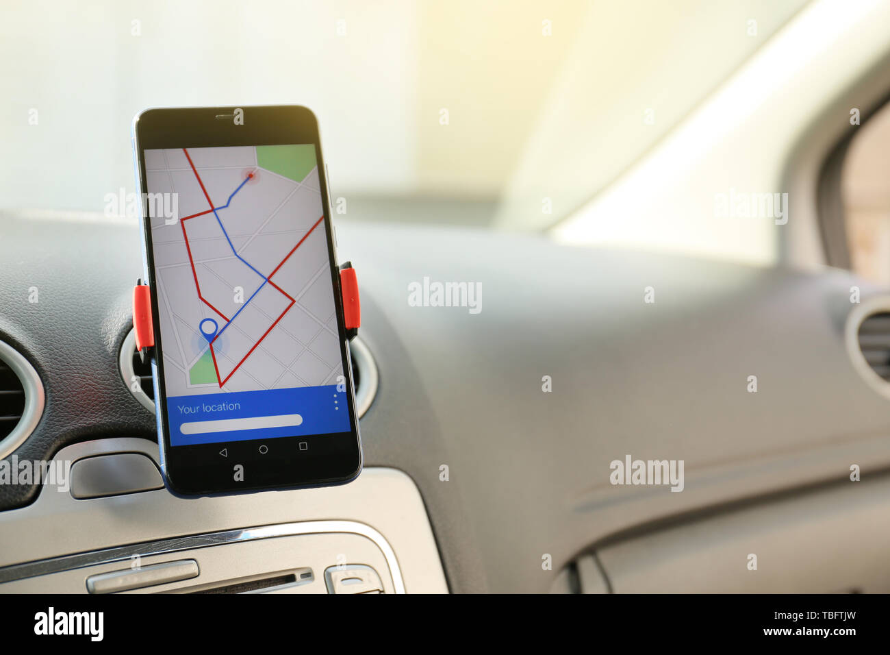 Mobile phone displaying map with route on screen for car driver Stock ...