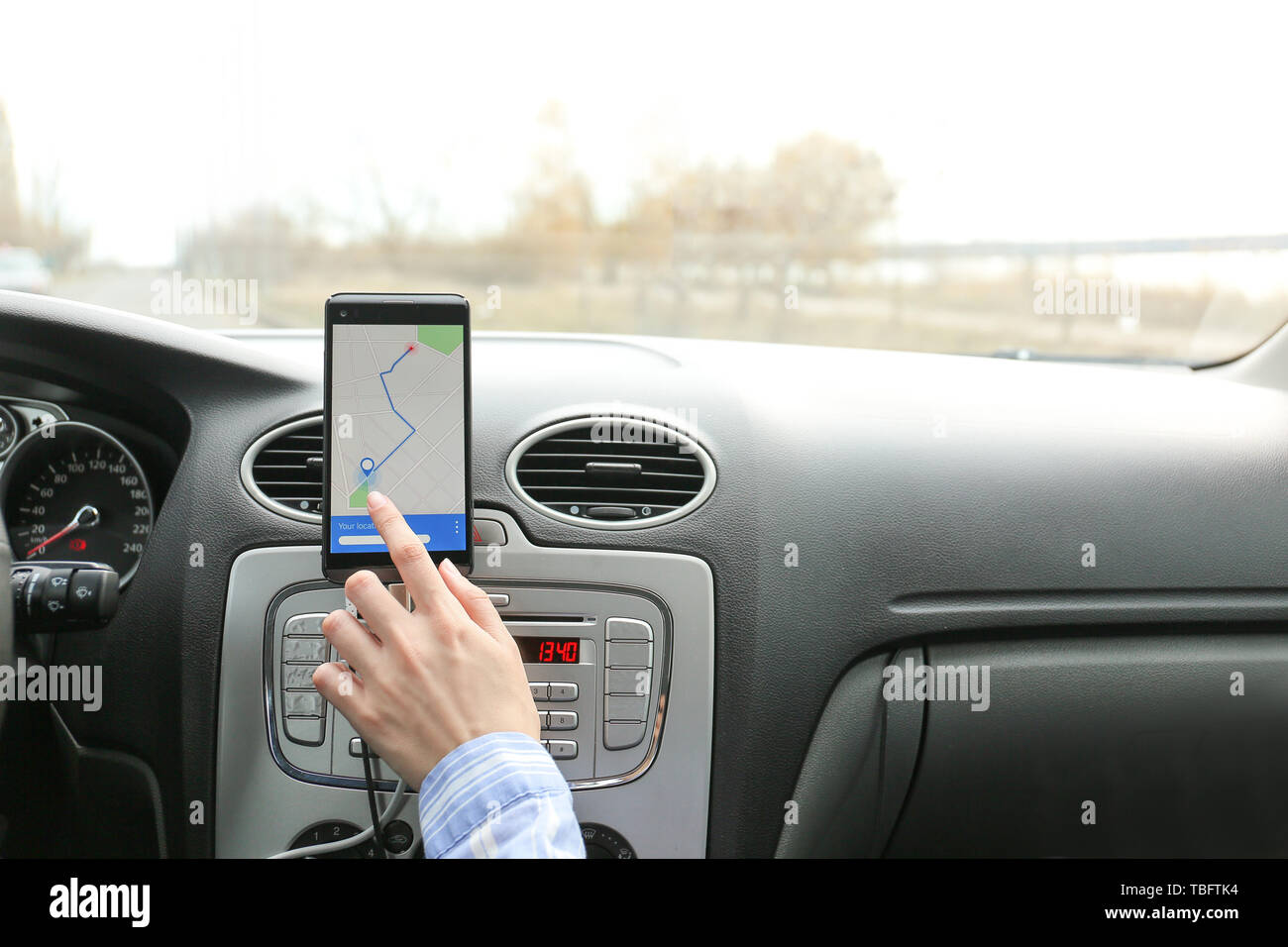 Car driver using mobile phone for navigation Stock Photo - Alamy