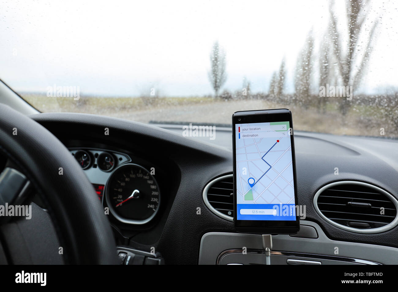Mobile phone displaying map with route on screen for car driver Stock ...