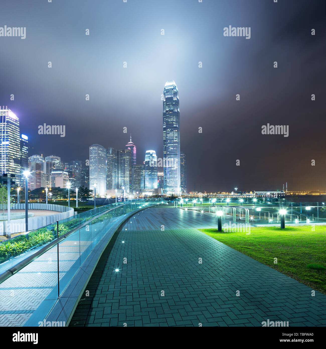 pathway in the night with modern city background Stock Photo - Alamy