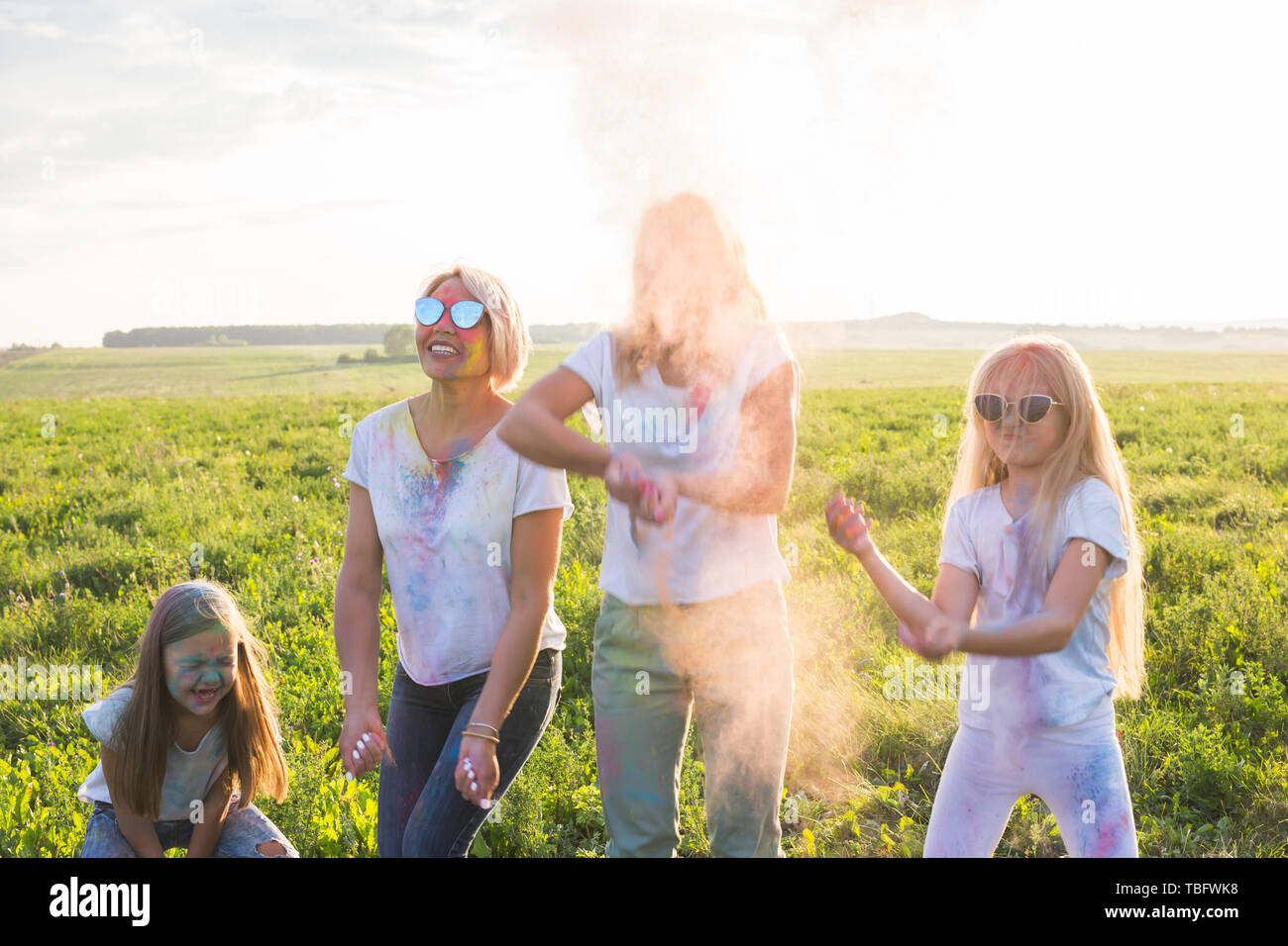 Holiday, summer and fun concept - Group of people dancing in field at ...