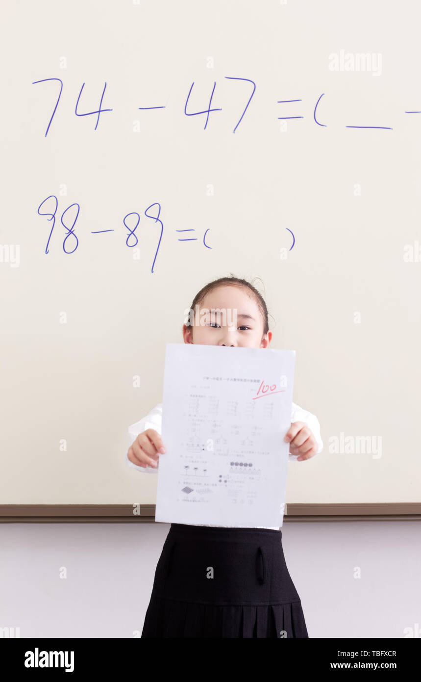 Three primary school students are in class in the classroom Stock Photo ...