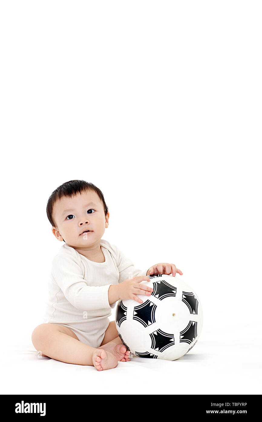 Asian children playing football Cut Out Stock Images & Pictures - Alamy