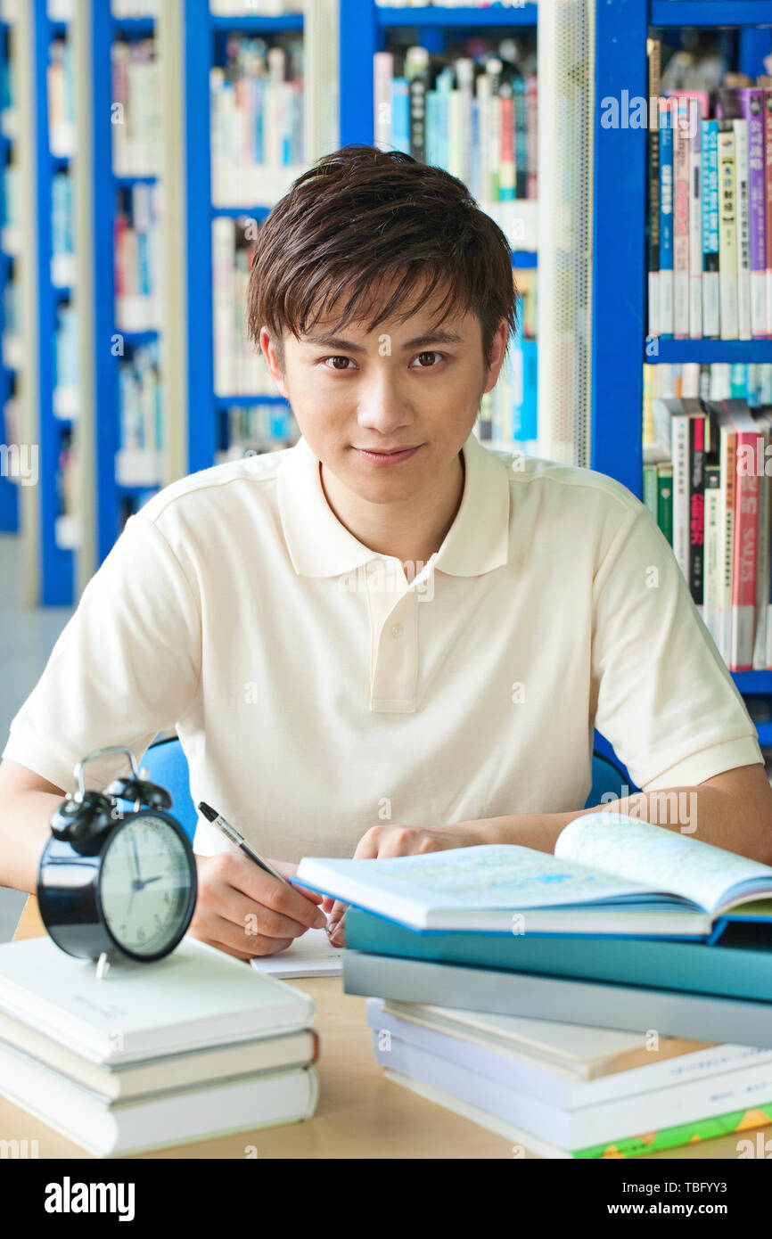 Studying in the library Stock Photo - Alamy