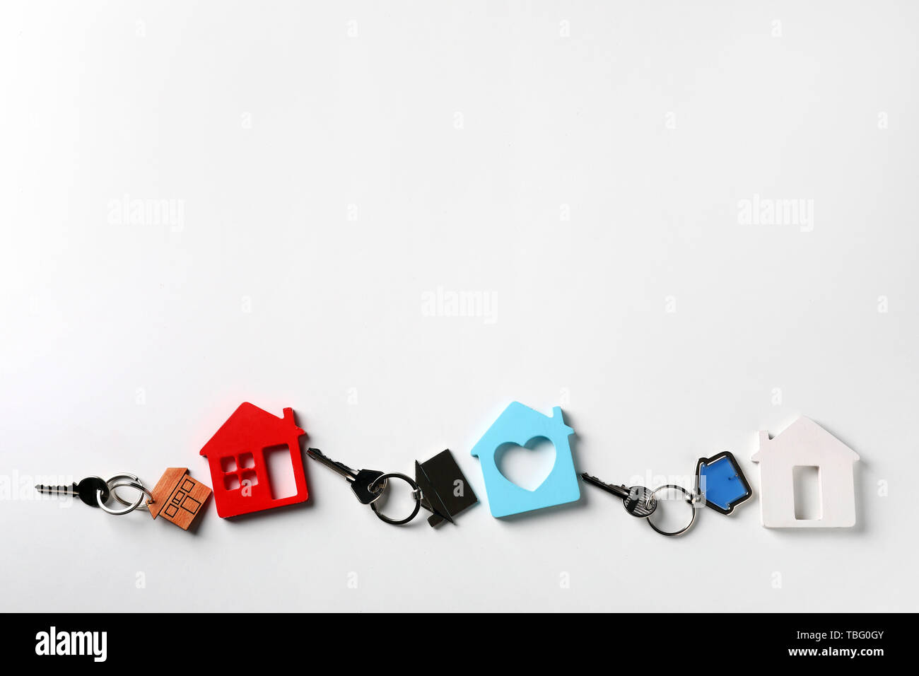 Models of house with keys on white background. Concept of earthquake ...