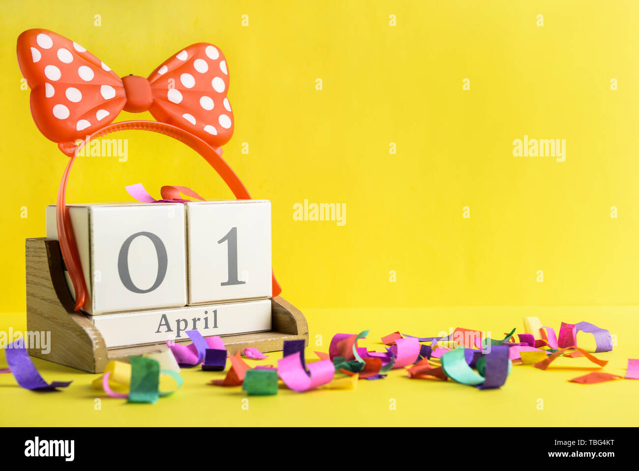 Party decor with calendar on color background. April Fool's Day ...