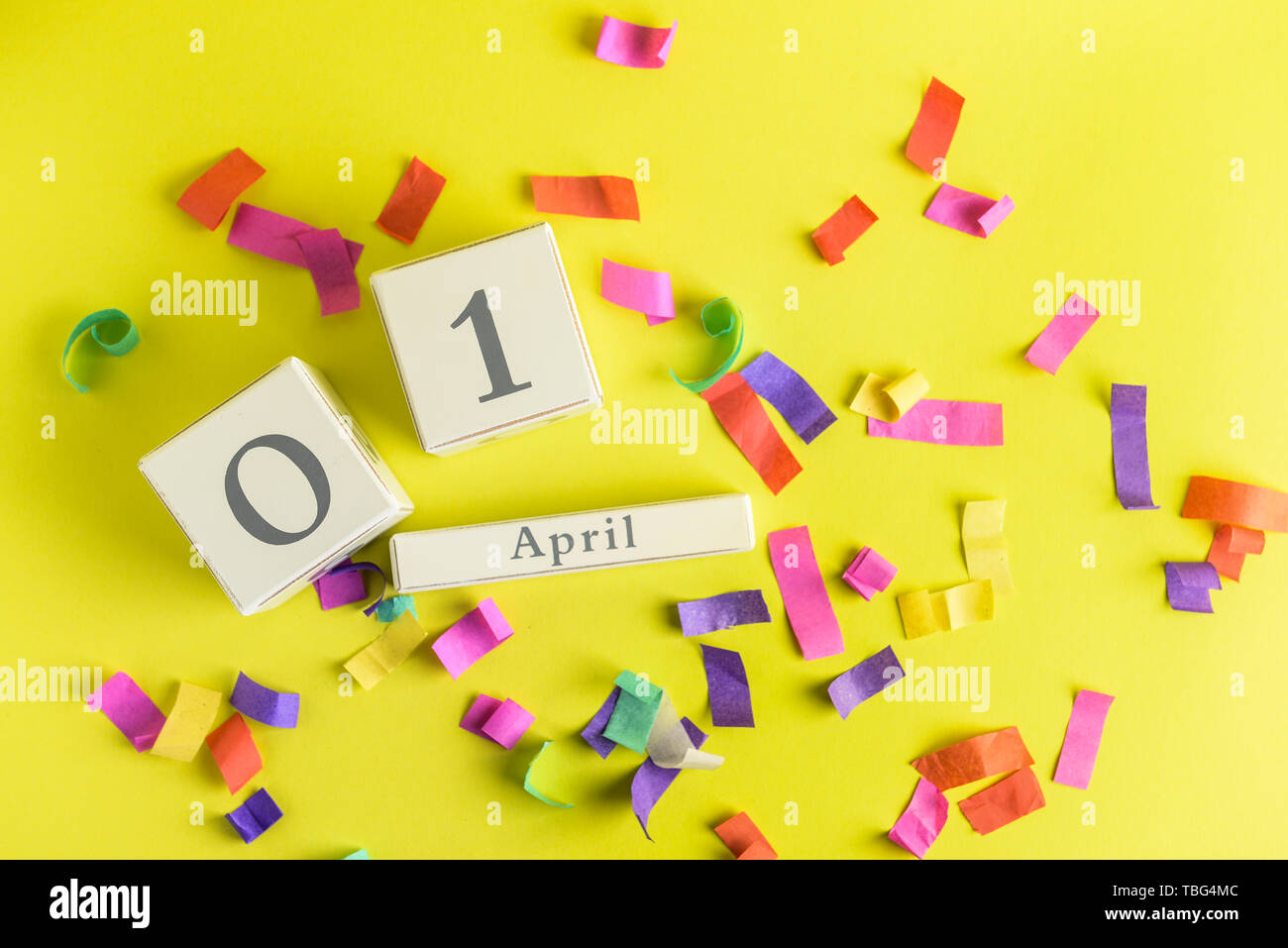 Party decor with calendar on color background. April Fool's Day ...