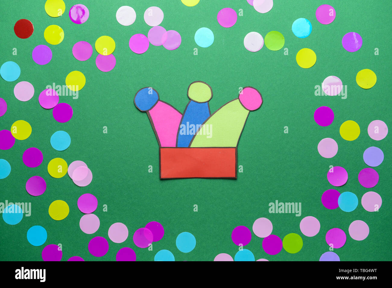 Paper crown with confetti on color background. April Fool's Day ...