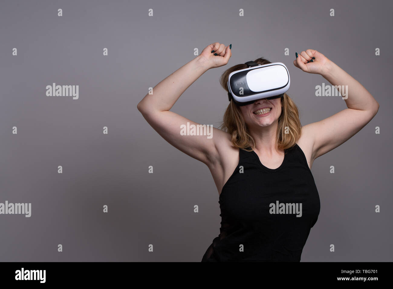 Happy girl using a VR gadget during a cyber reality simulation Stock ...