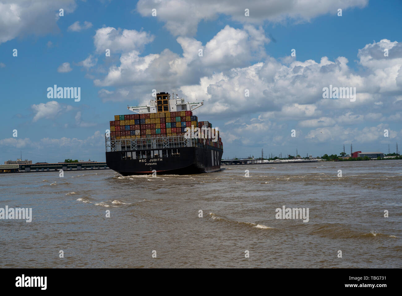 New Orleans, LA, USA -- May 24, 2019. A container ship makes its way ...