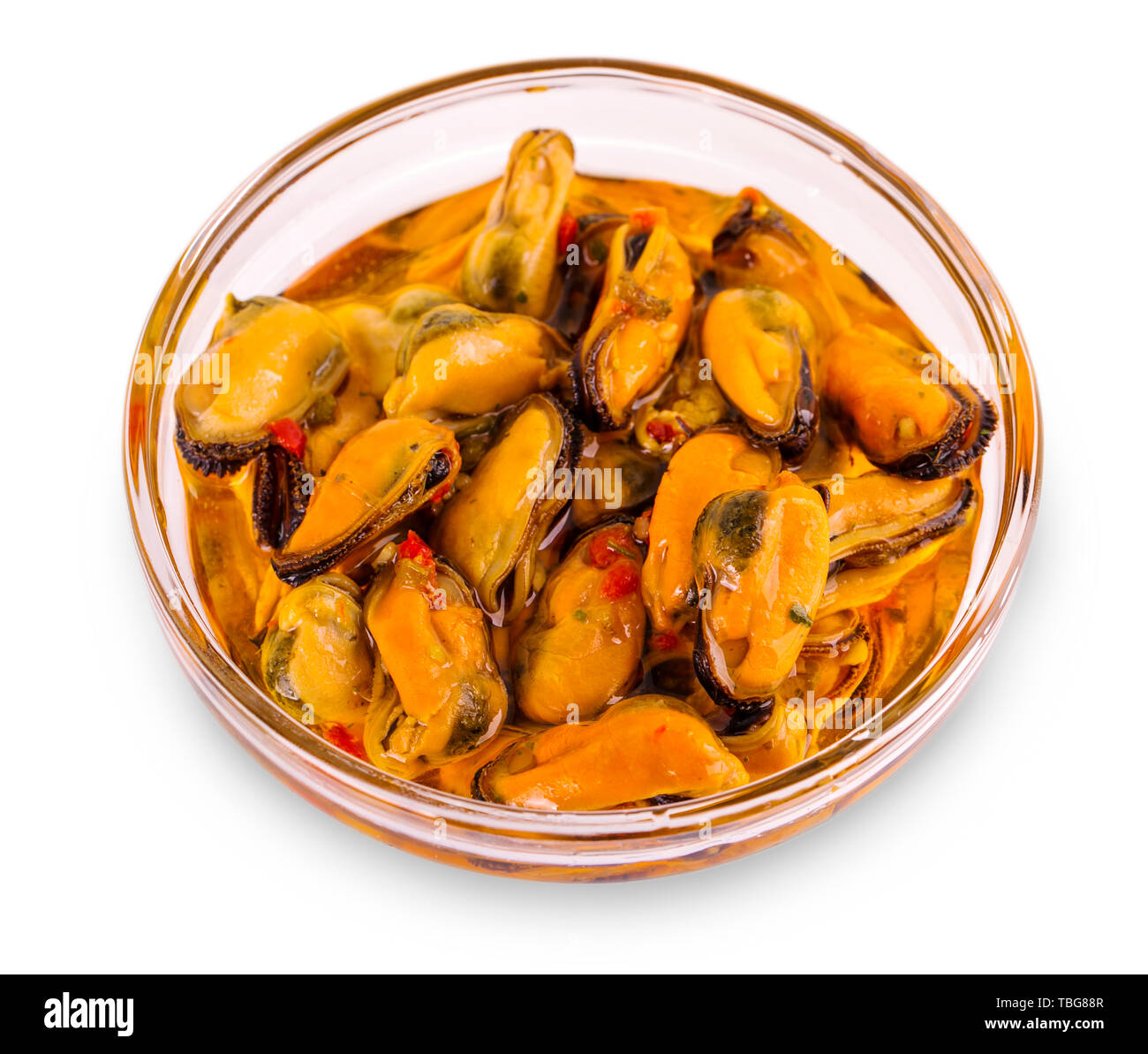 serving of pickled sea mussels in a glass bowl on a white background ...