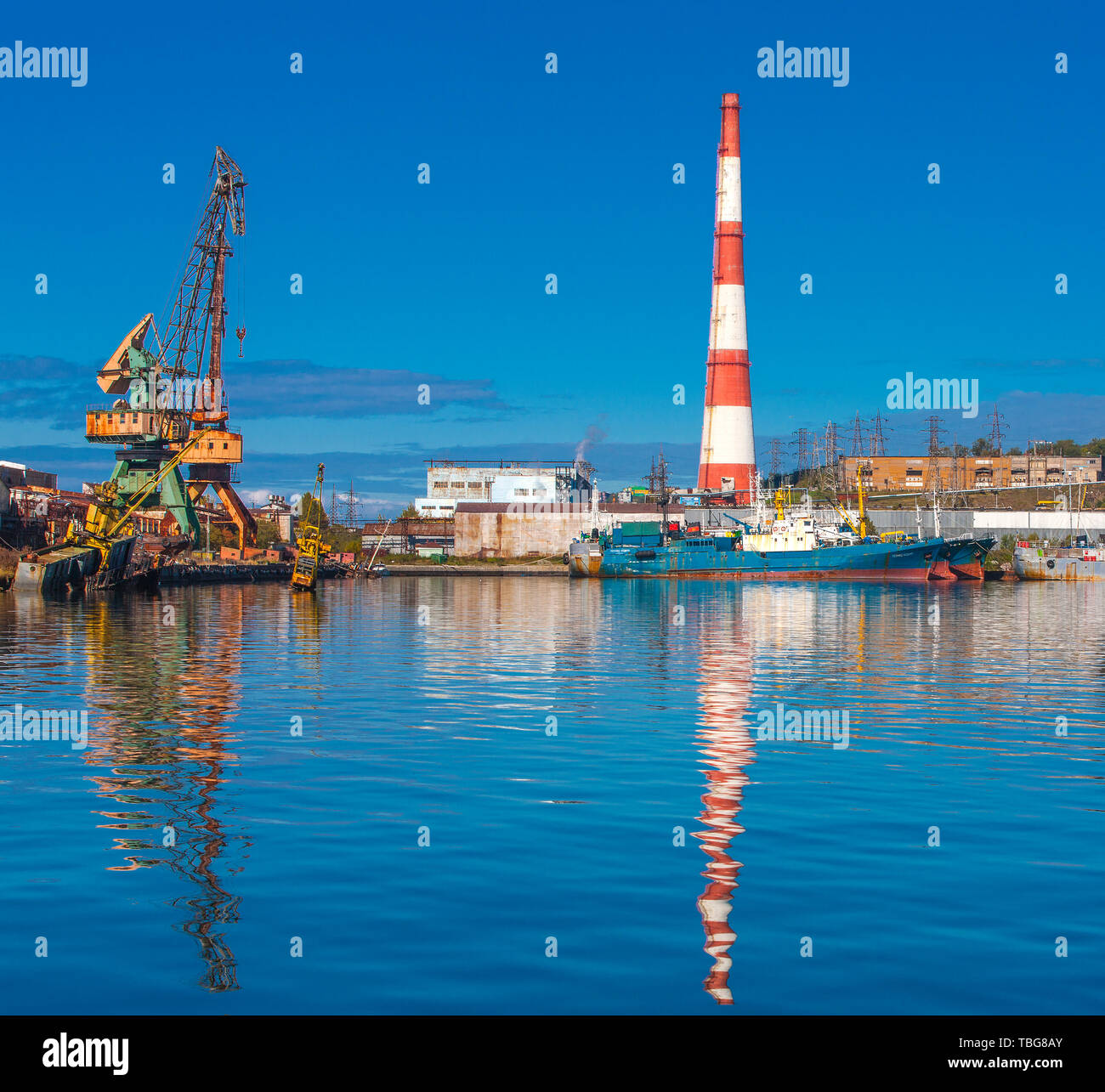 large striped power plant tube with reflection in water Stock Photo - Alamy