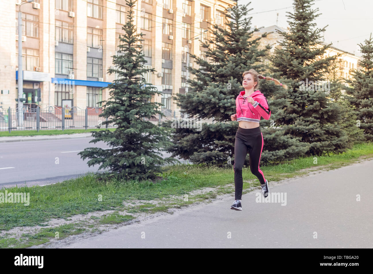 girl running along the road Stock Photo - Alamy