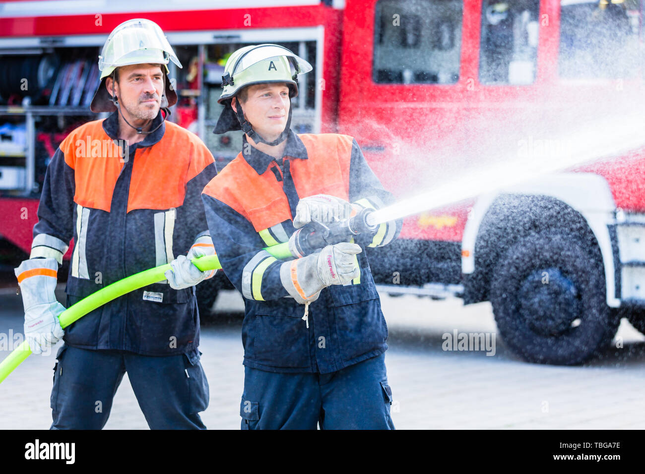 men of the fire department extinguish fire Stock Photo - Alamy