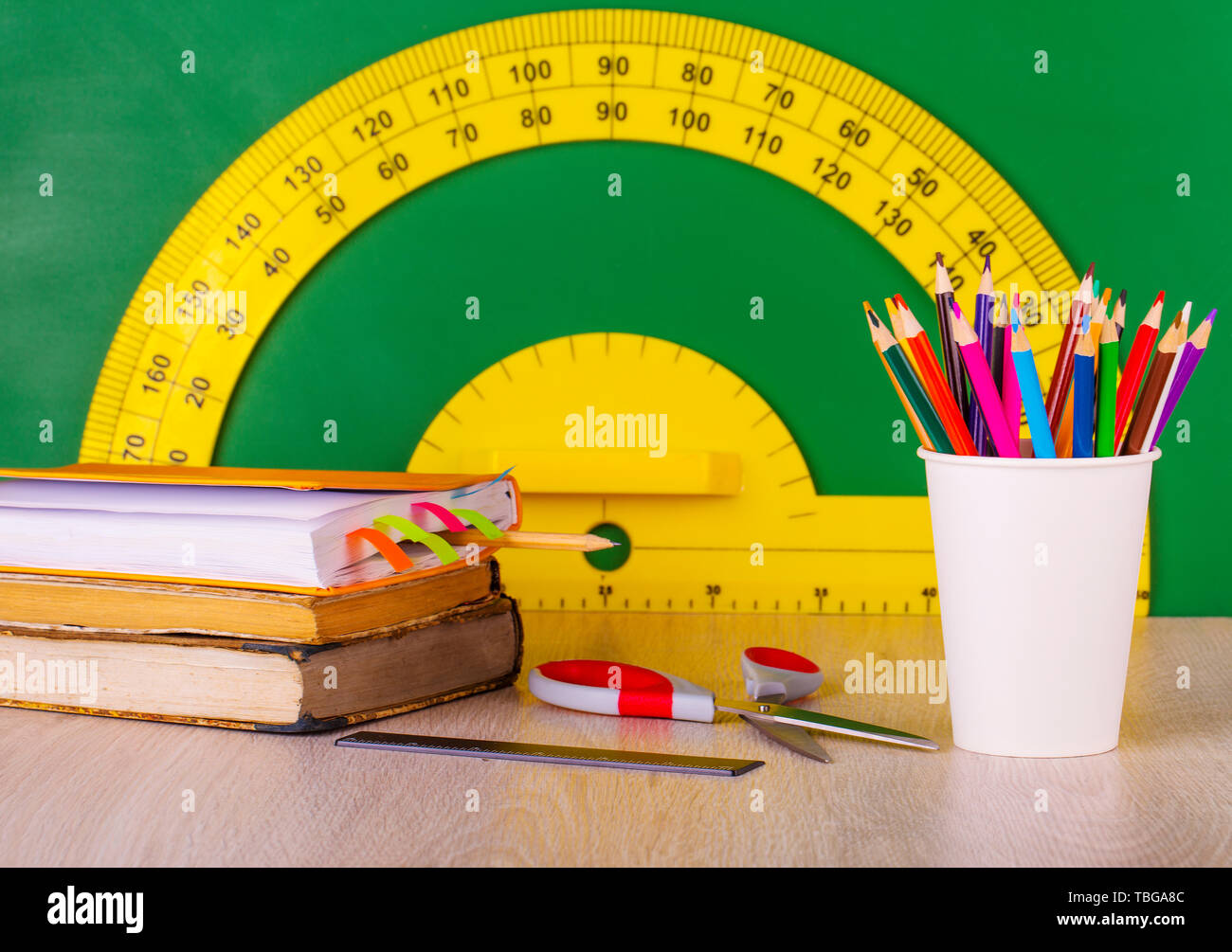School concept: colore pencil, book, ruler, scissors and green ...
