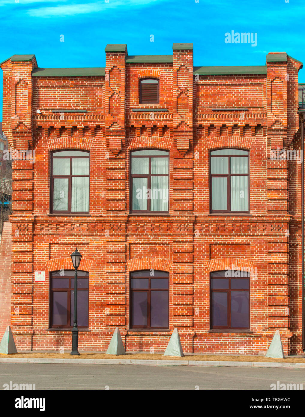 facade of the three-storey red brick building on white background Stock ...