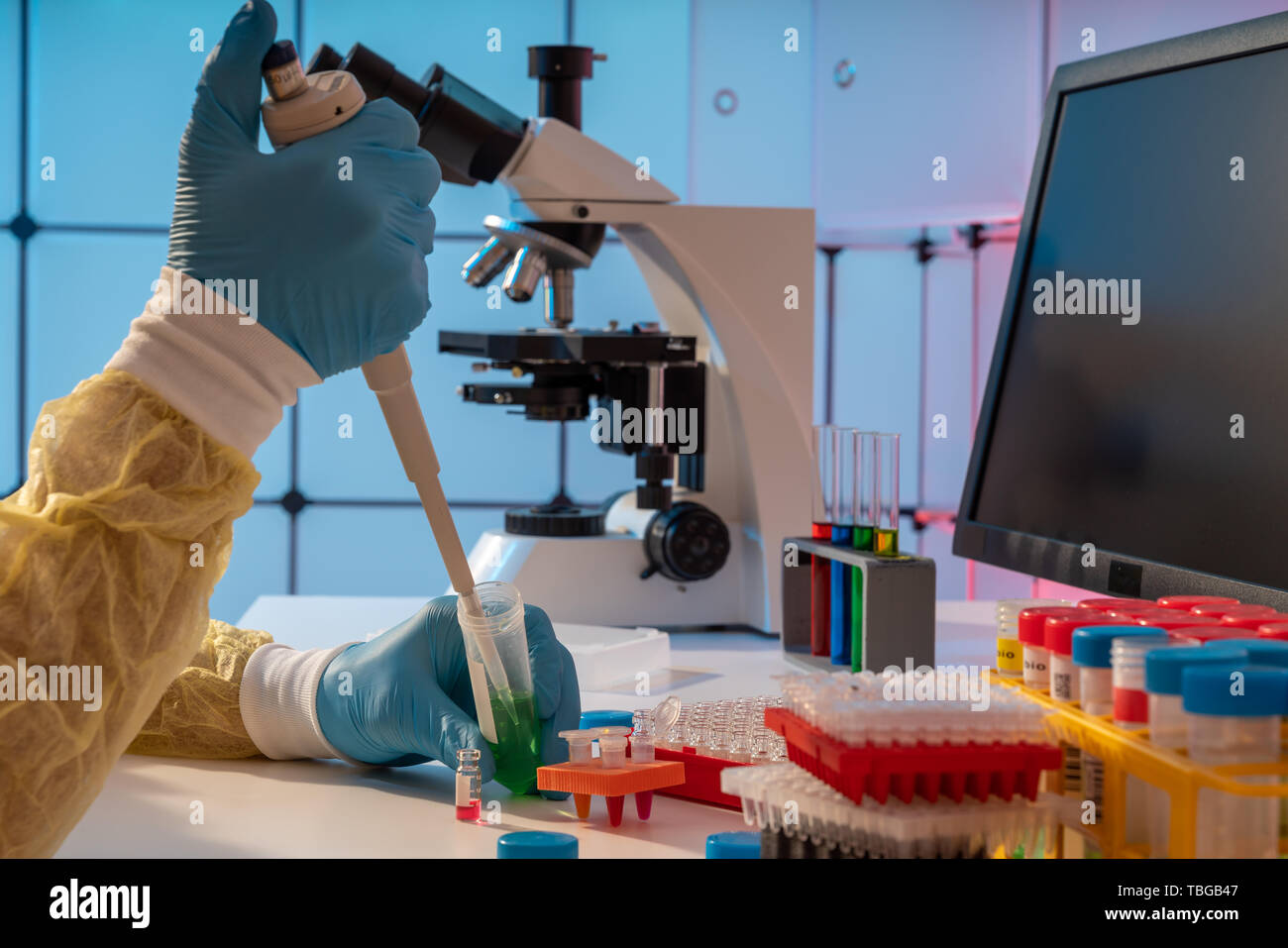 Scientific experiment in microbiological lab. Microscope and test tube ...