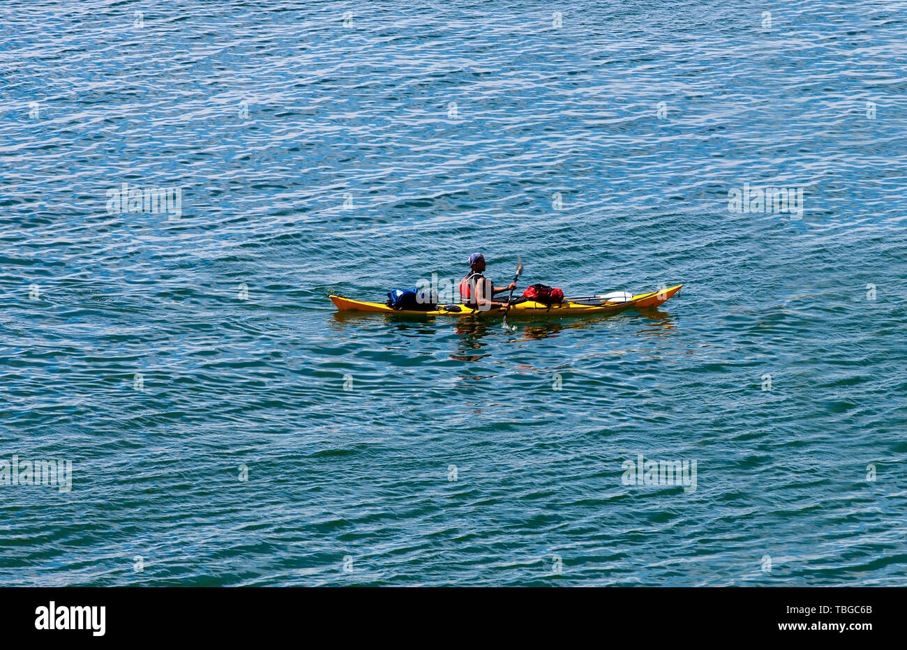 A man in a sea kayak on Pasific ocean Stock Photo - Alamy
