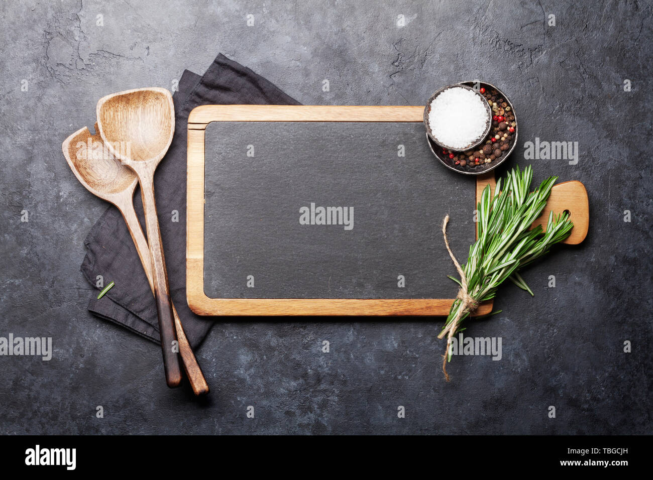 Cooking ingredients and utensils on stone table. Top view with ...