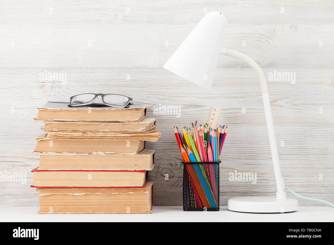 Home office workplace with stack of old books and supplies. Education ...