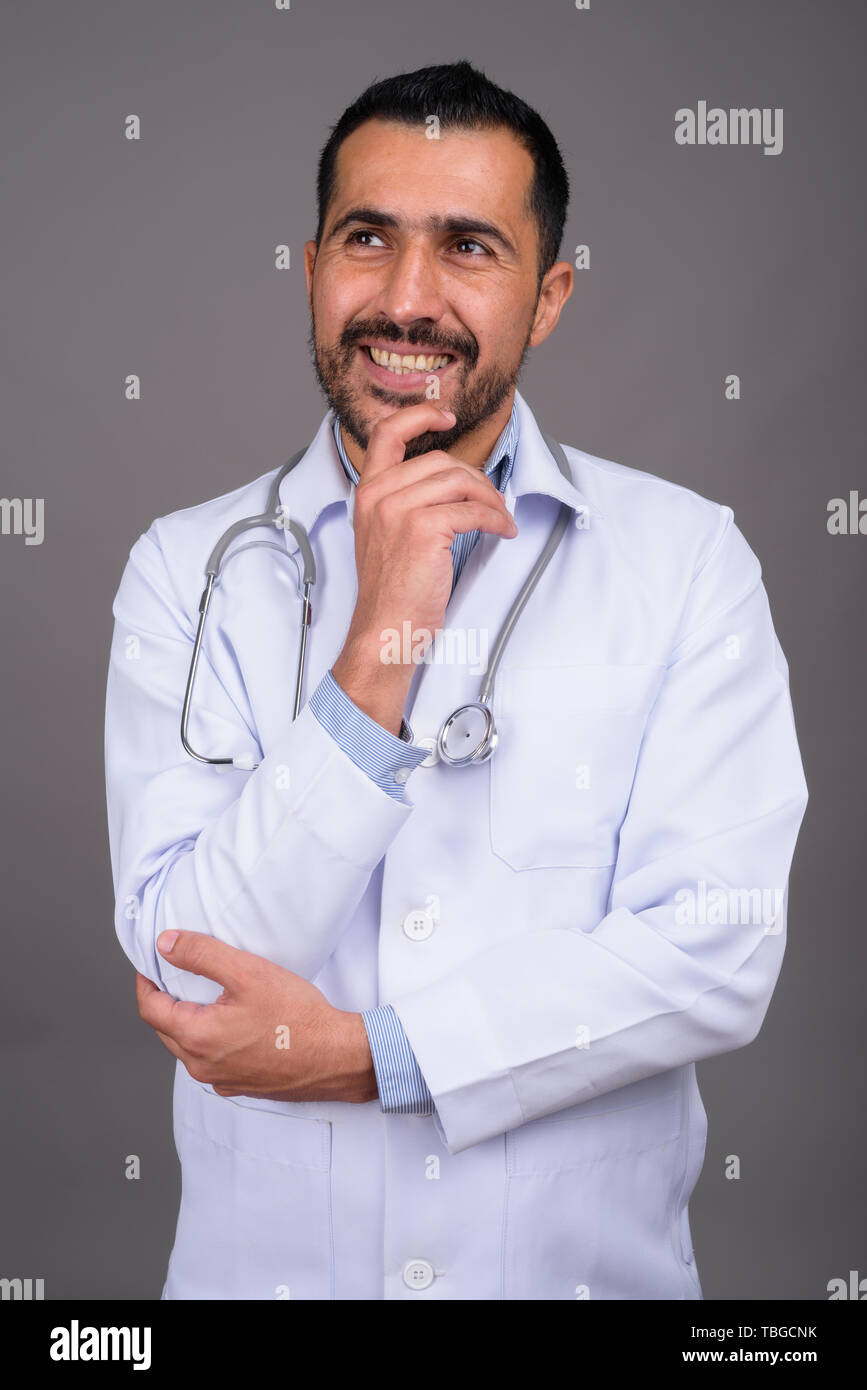 Happy persian man doctor thinking hi-res stock photography and images ...