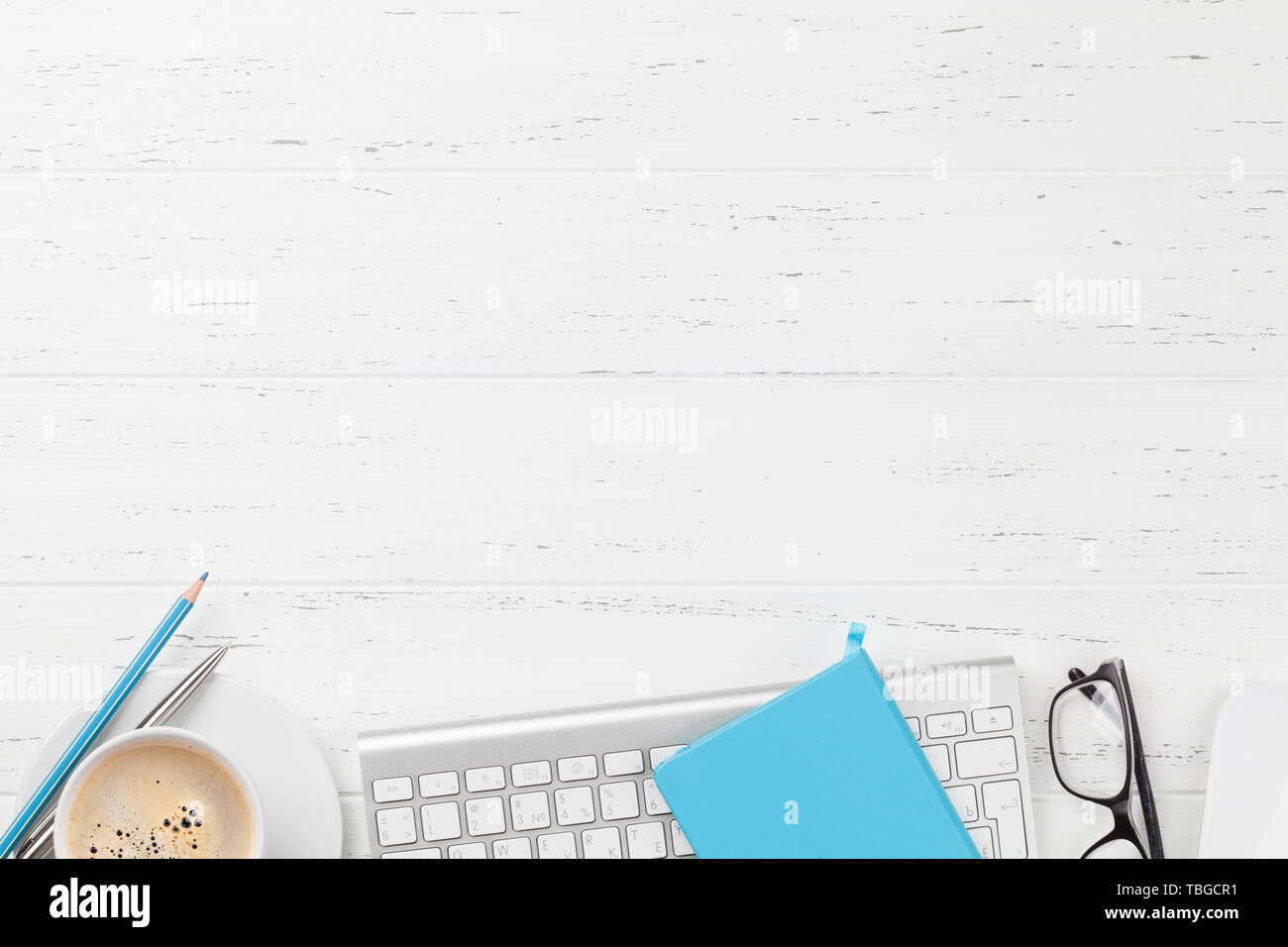 Office workplace table with report page, coffee cup, supplies and ...