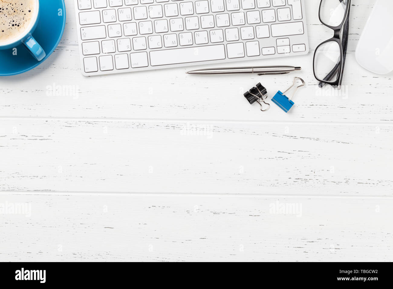 Office workplace table with coffee cup, supplies and computer. Flat lay ...