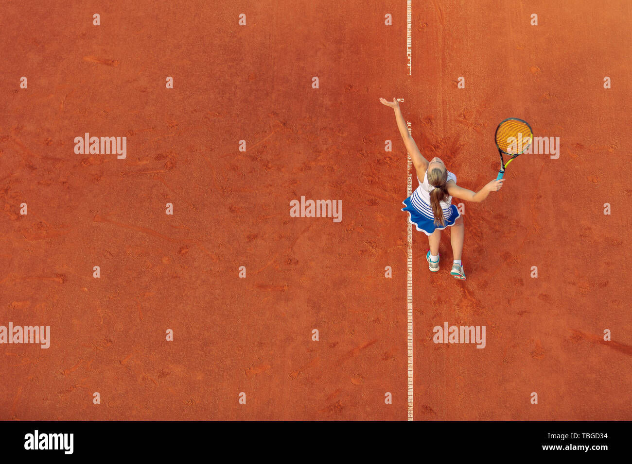 Aerial shot of a female tennis player on a court during match. Young ...