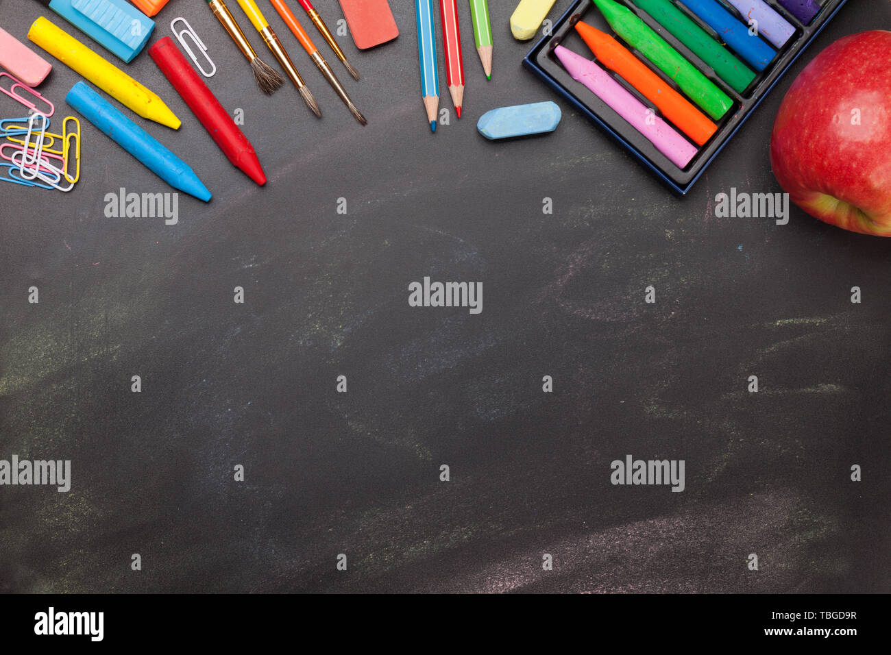 School education supplies on chalkboard backdrop. Back to school template concept. Top view flat ...