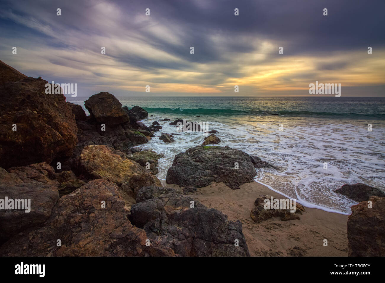 Dramatic sky at sunset along Point Dume State Beach with waves crashing ...