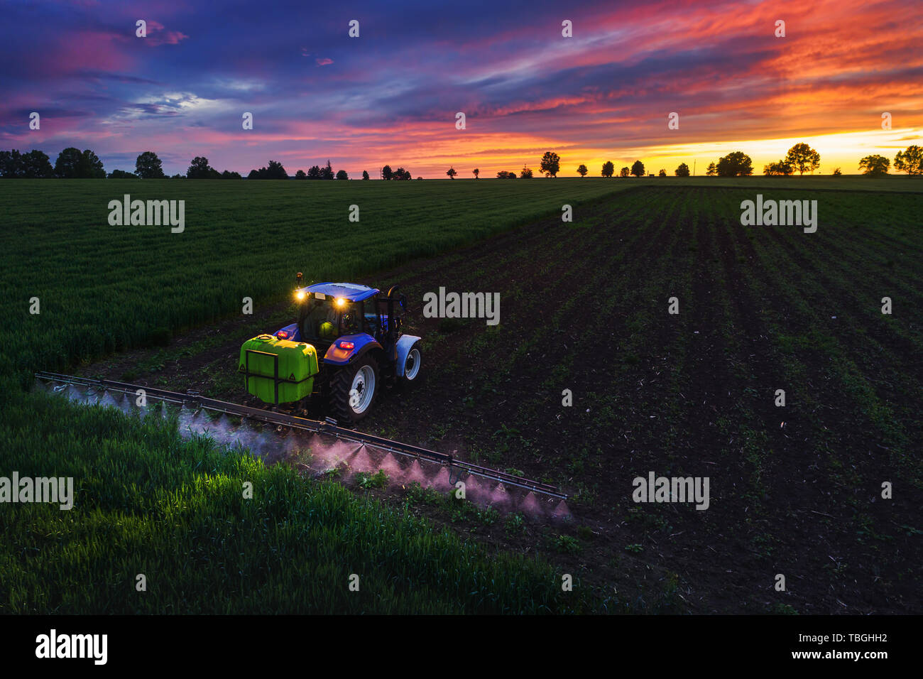 Tractor spraying field at spring,aerial view Stock Photo - Alamy