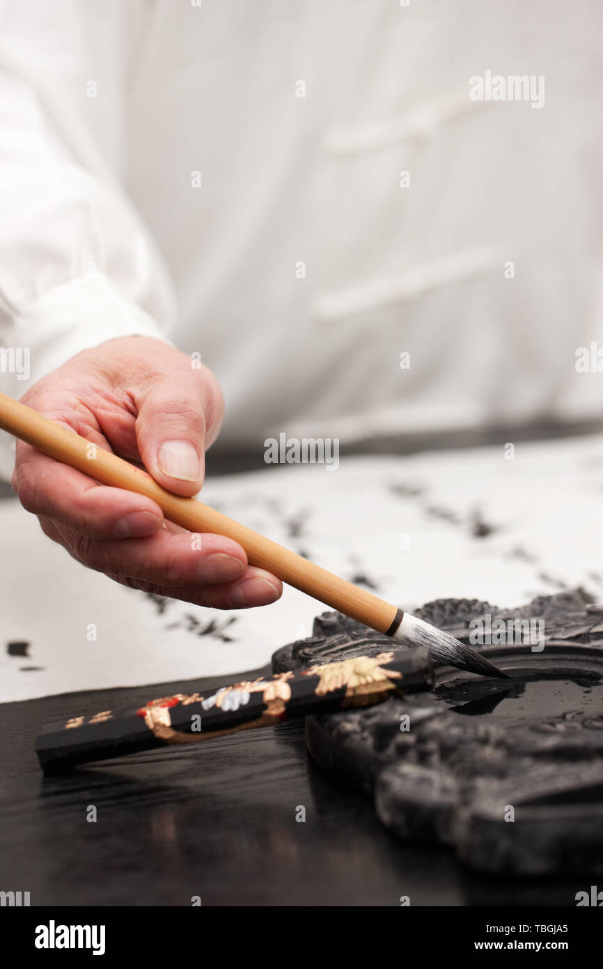 An old man practicing calligraphy Stock Photo - Alamy