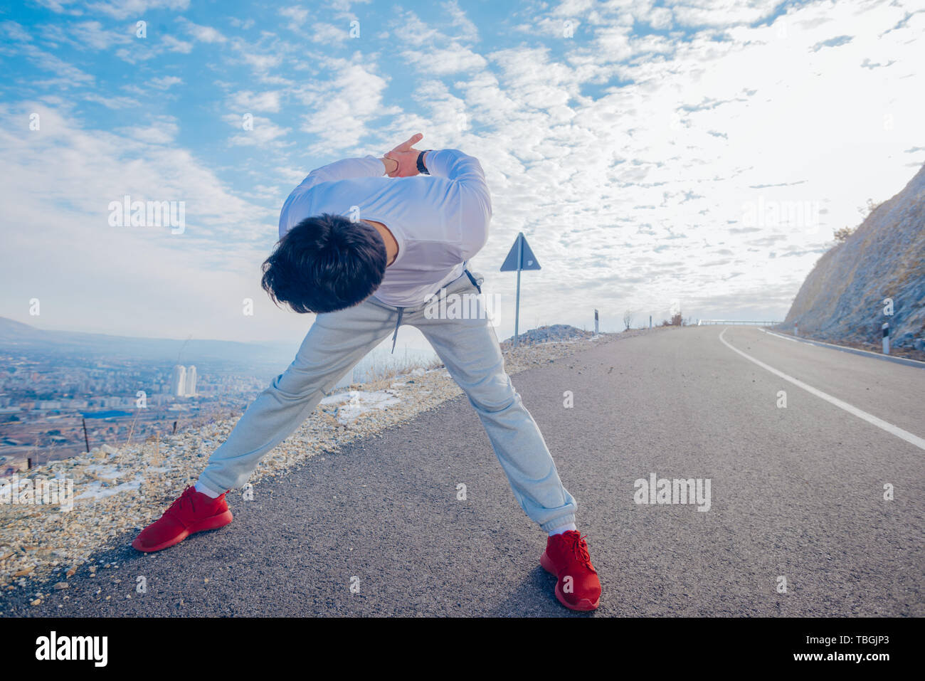 Fit male stretching and performing his morning routines while wearing a ...