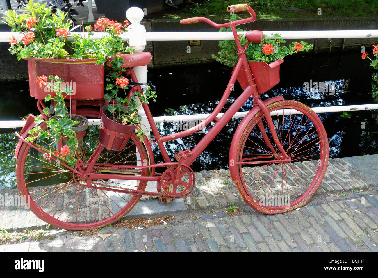 Old-fashioned Dutch city bike near a bridge over canal in the Old Town ...