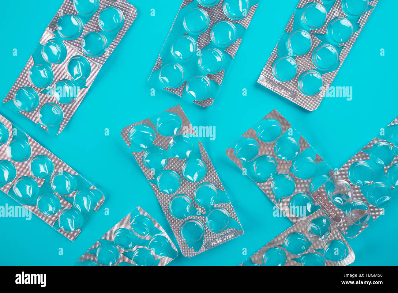 many empty tablet packs on blue background Stock Photo - Alamy