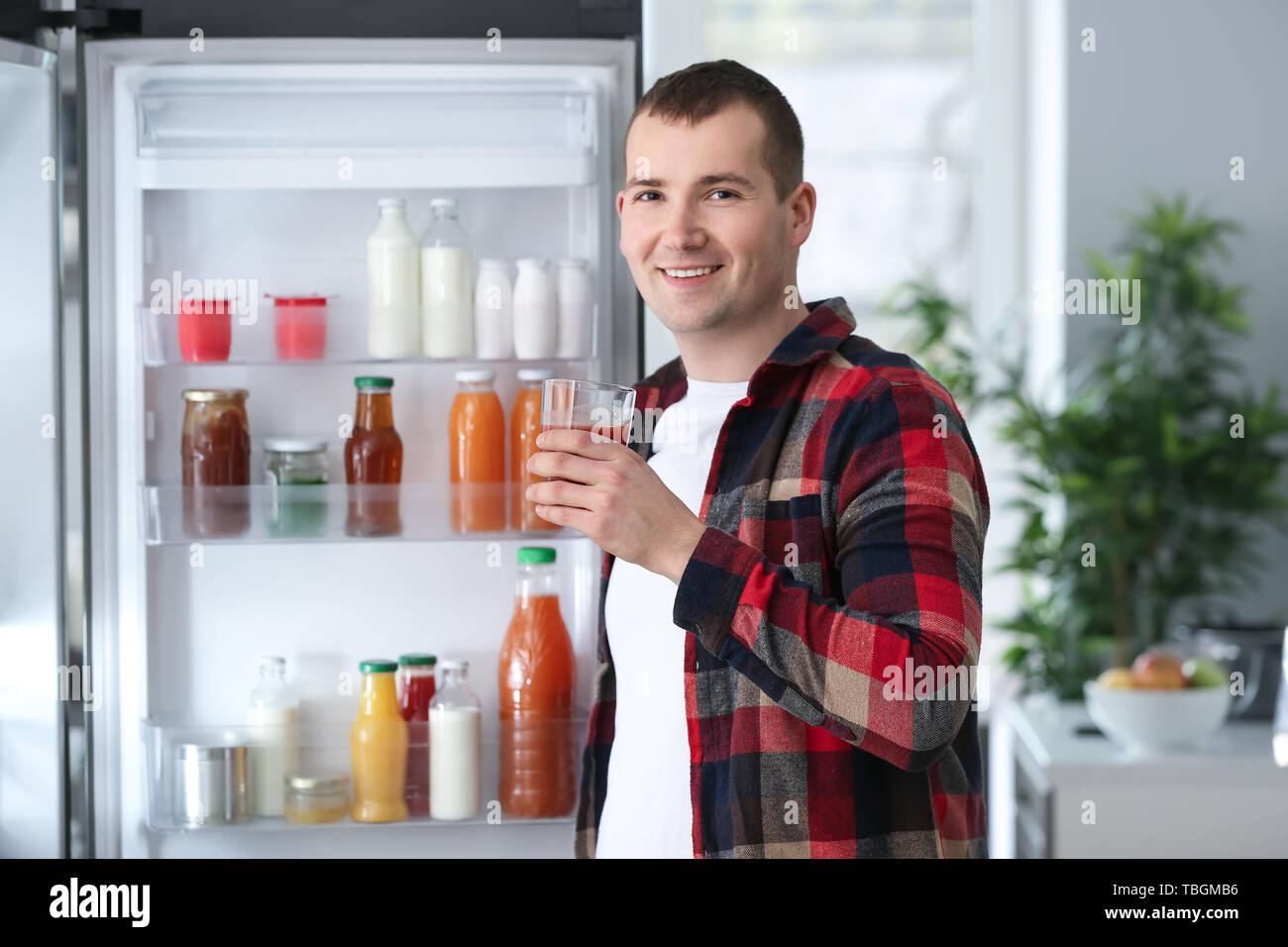 Hungry man standing open fridge hi-res stock photography and images - Alamy