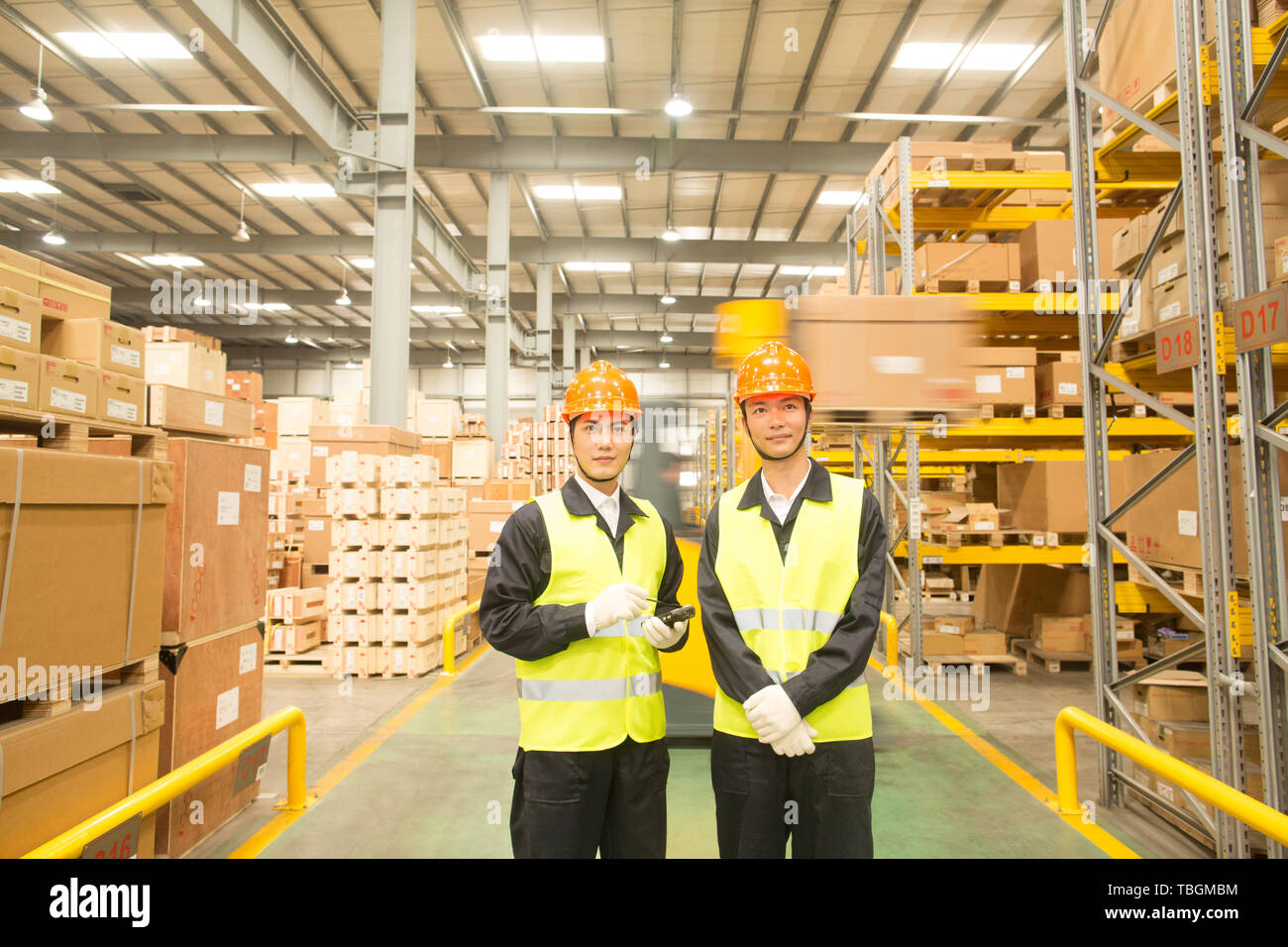 Logistics personnel load and unload cargo at the warehouse Stock Photo ...