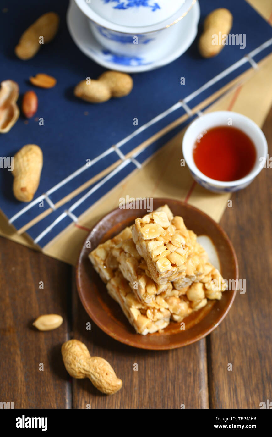 Peanut crisp and black tea Stock Photo - Alamy