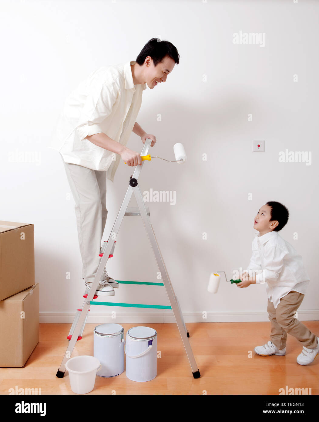 Kids help decorate the new house Stock Photo - Alamy