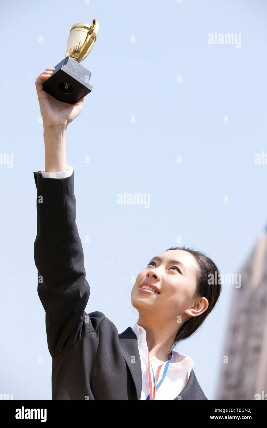 Woman hand raised gold medal hi-res stock photography and images - Alamy